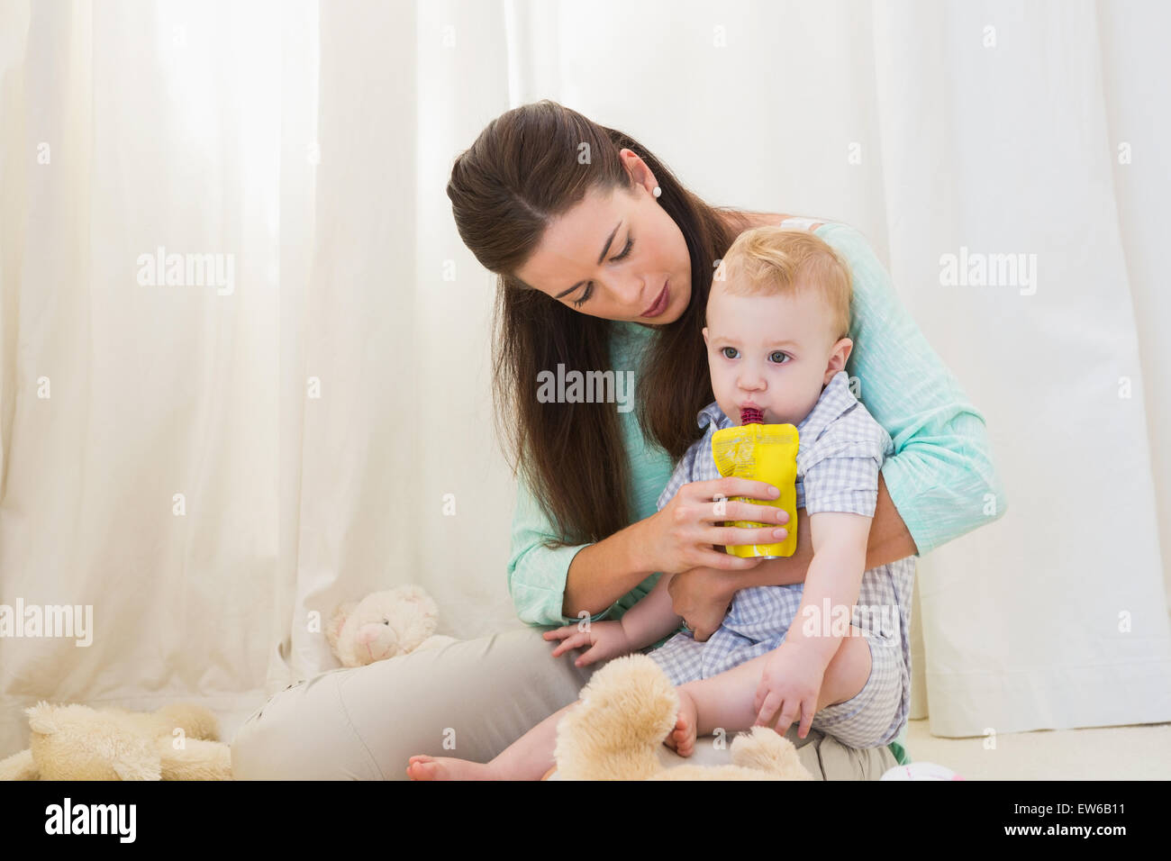 Mother and baby sitting on floor Stock Photo - Alamy