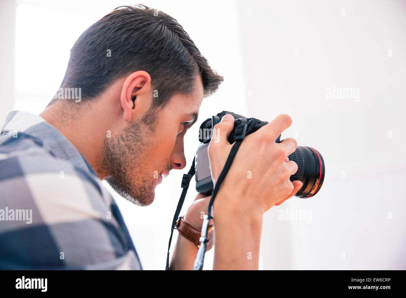 Casual man using photo camera Stock Photo - Alamy