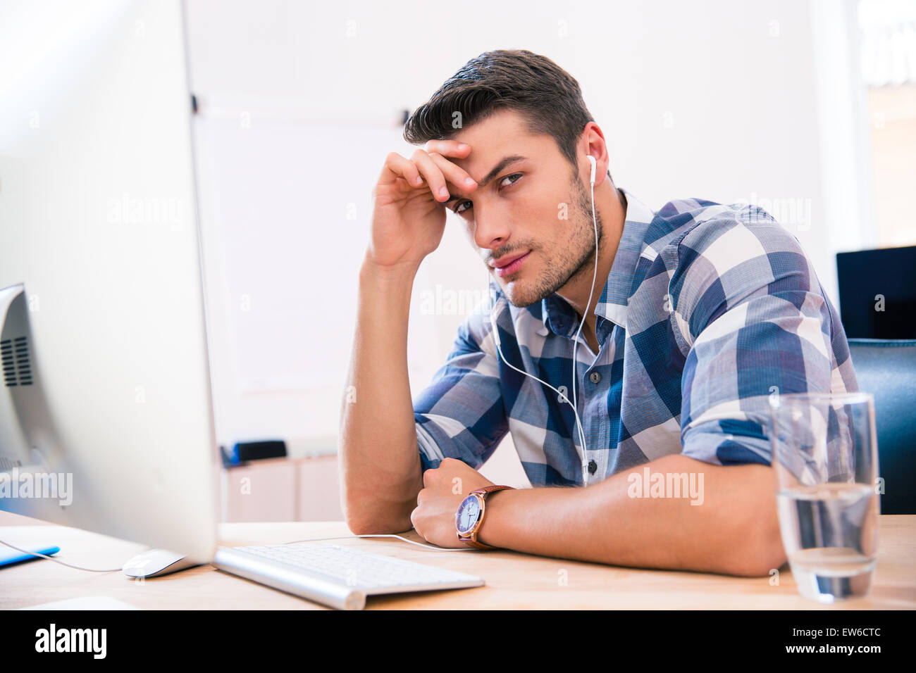 Handsome businessman in casual cloth and headphones sitting at the ...