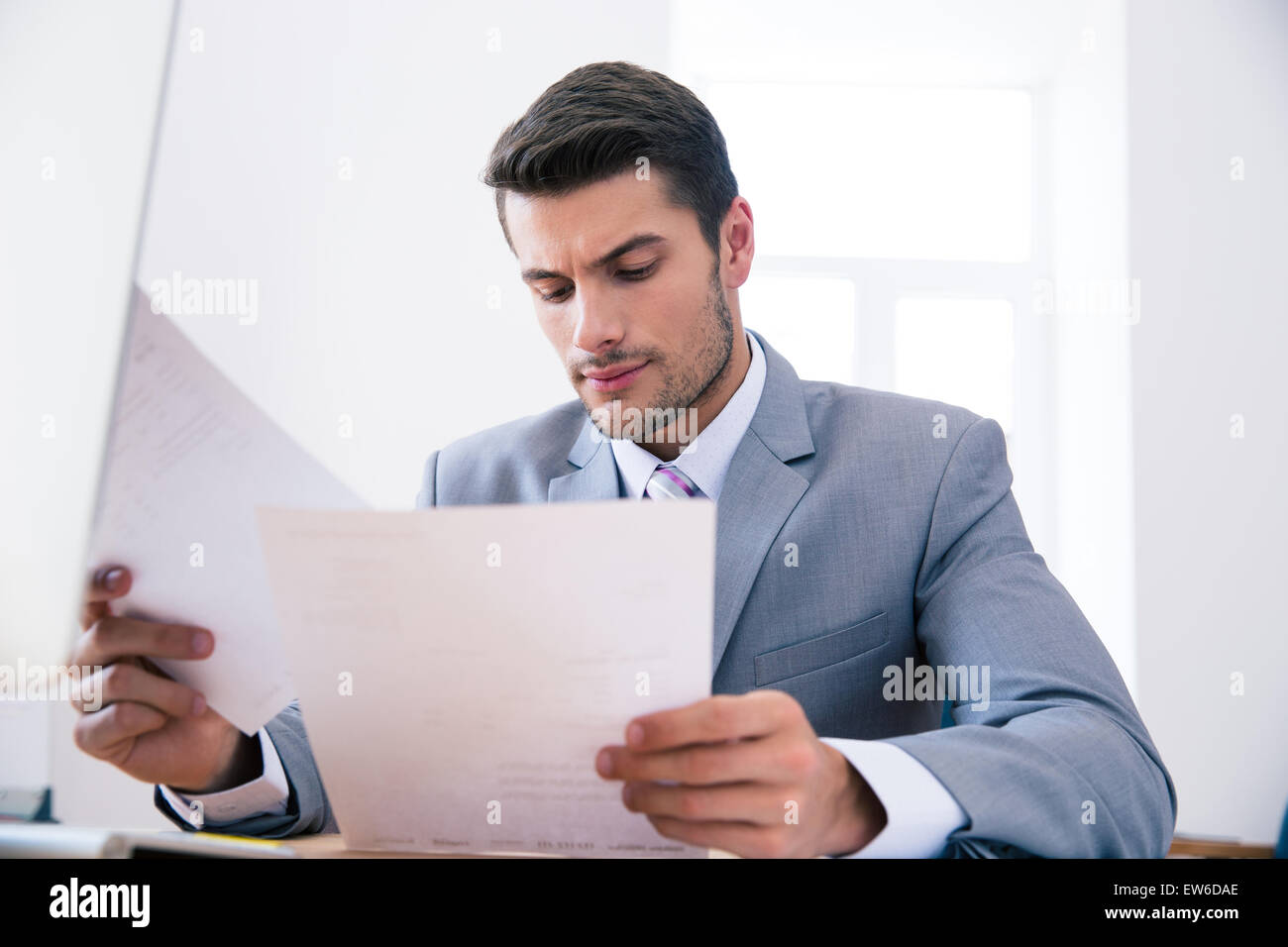 Handsome businessman reading documents hi-res stock photography and ...
