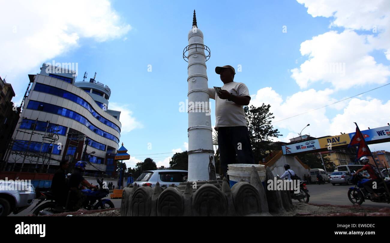 Kathmandu. 18th June, 2015. A man gives a final touch to the replica of ...
