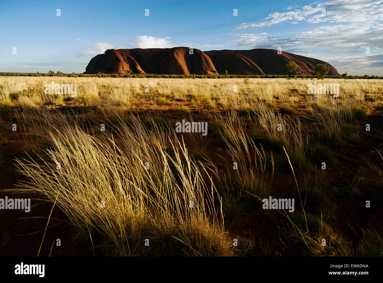 The sunrises over Uluru, Australia's sacred sandstone rock, more ...