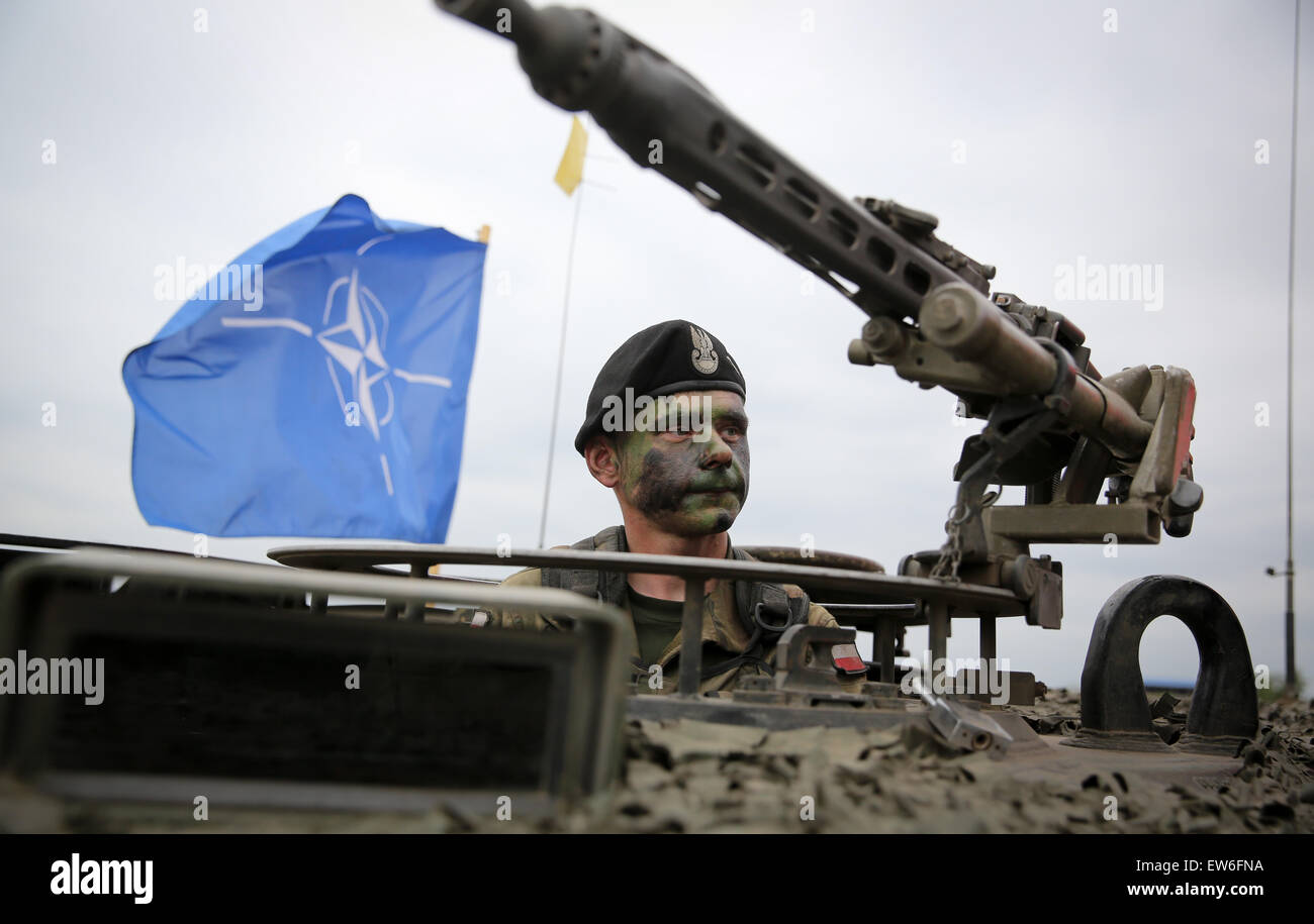 Sagan, Poland. 18th June, 2015. A Polish soldier monitors the area from ...