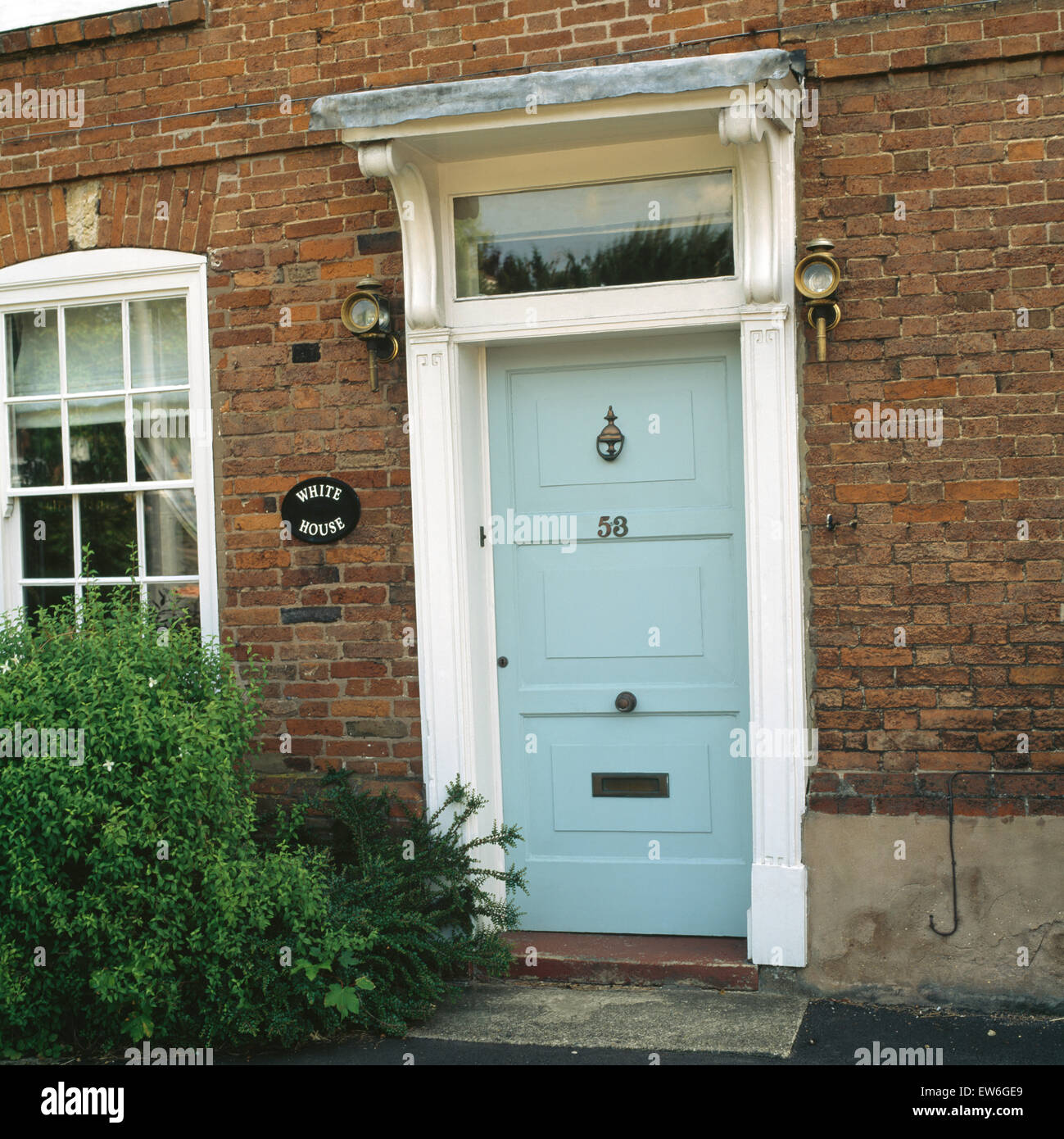 Exterior of a country cottage with a pale blue front door Stock Photo ...