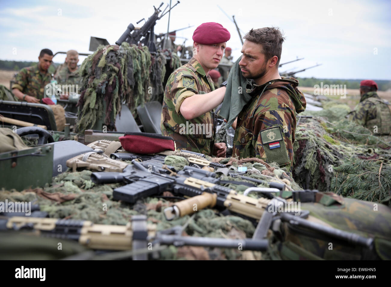 Sagan, Poland. 18th June, 2015. Soldiers remove camouflage paint from ...