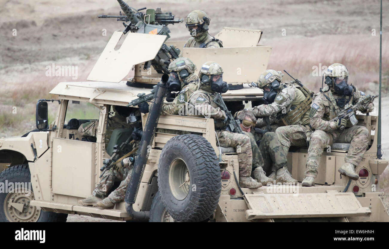 Sagan, Poland. 18th June, 2015. NATO soldiers ride a vehicle during the ...