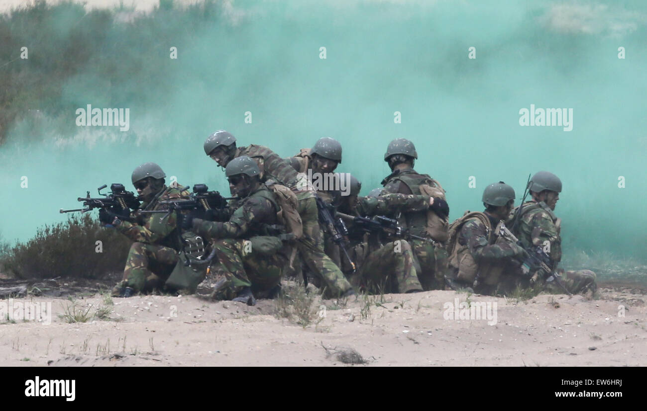 Sagan, Poland. 18th June, 2015. NATO soldiers fire their weapons during ...