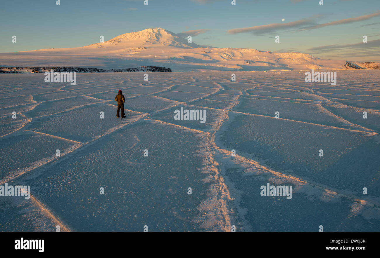 A man looks across the frozen ocean cracks in the McMurdo Sound Region ...