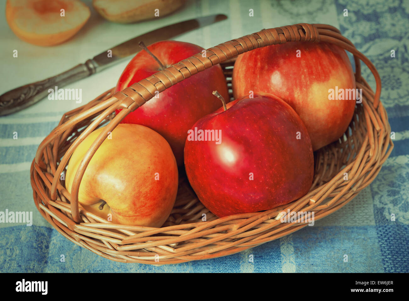 Large ripe apples are in a wattled basket on a table Stock Photo - Alamy