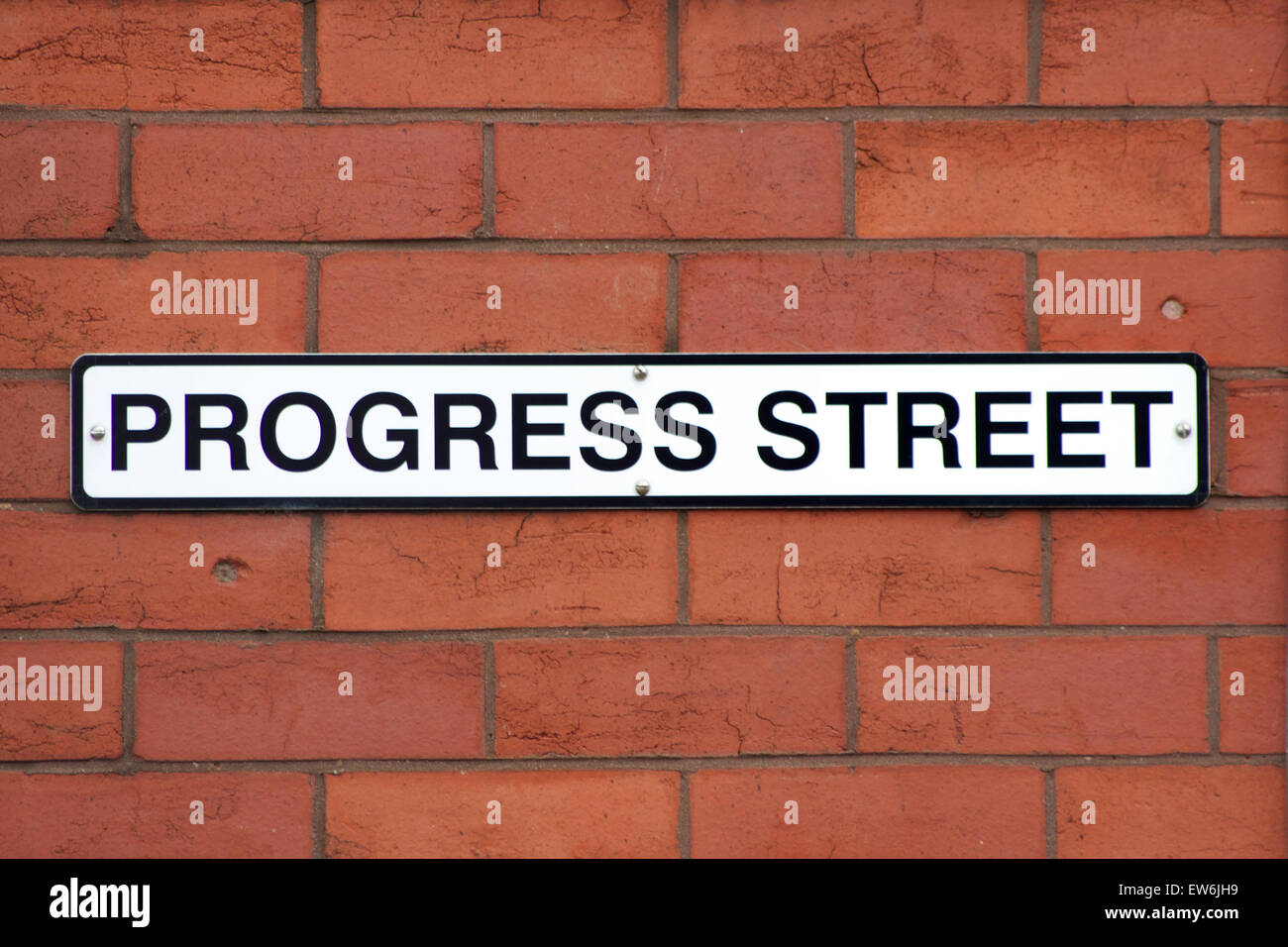 "progress" street sign on red brick wall Stock Photo - Alamy