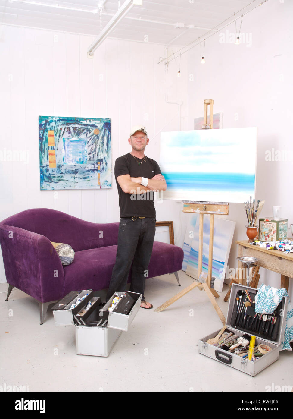Portrait of an artist standing in his studio Stock Photo - Alamy