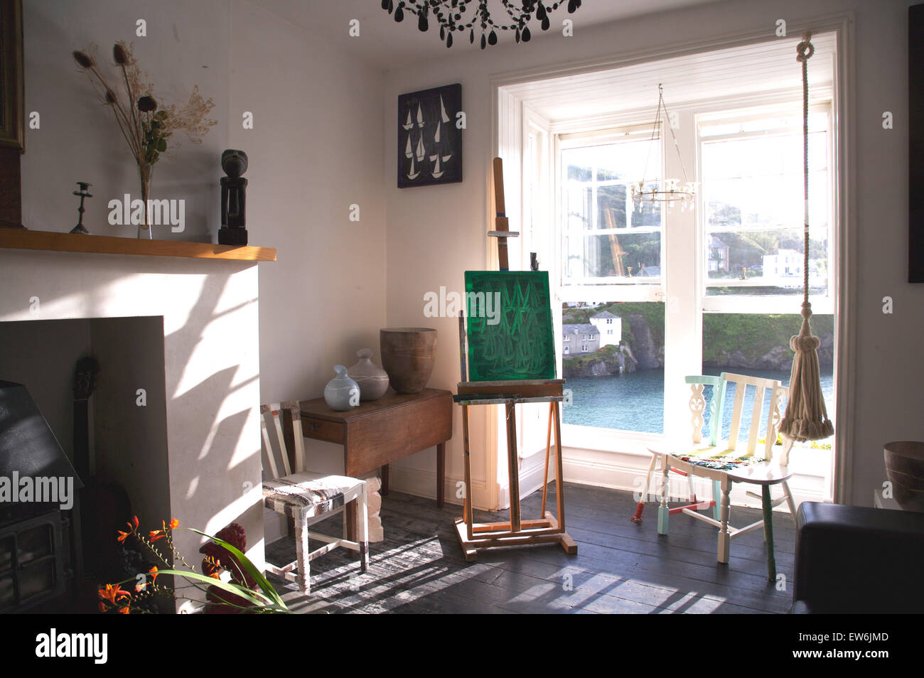 Artist's studio with wooden easel beside open window with view of Port ...