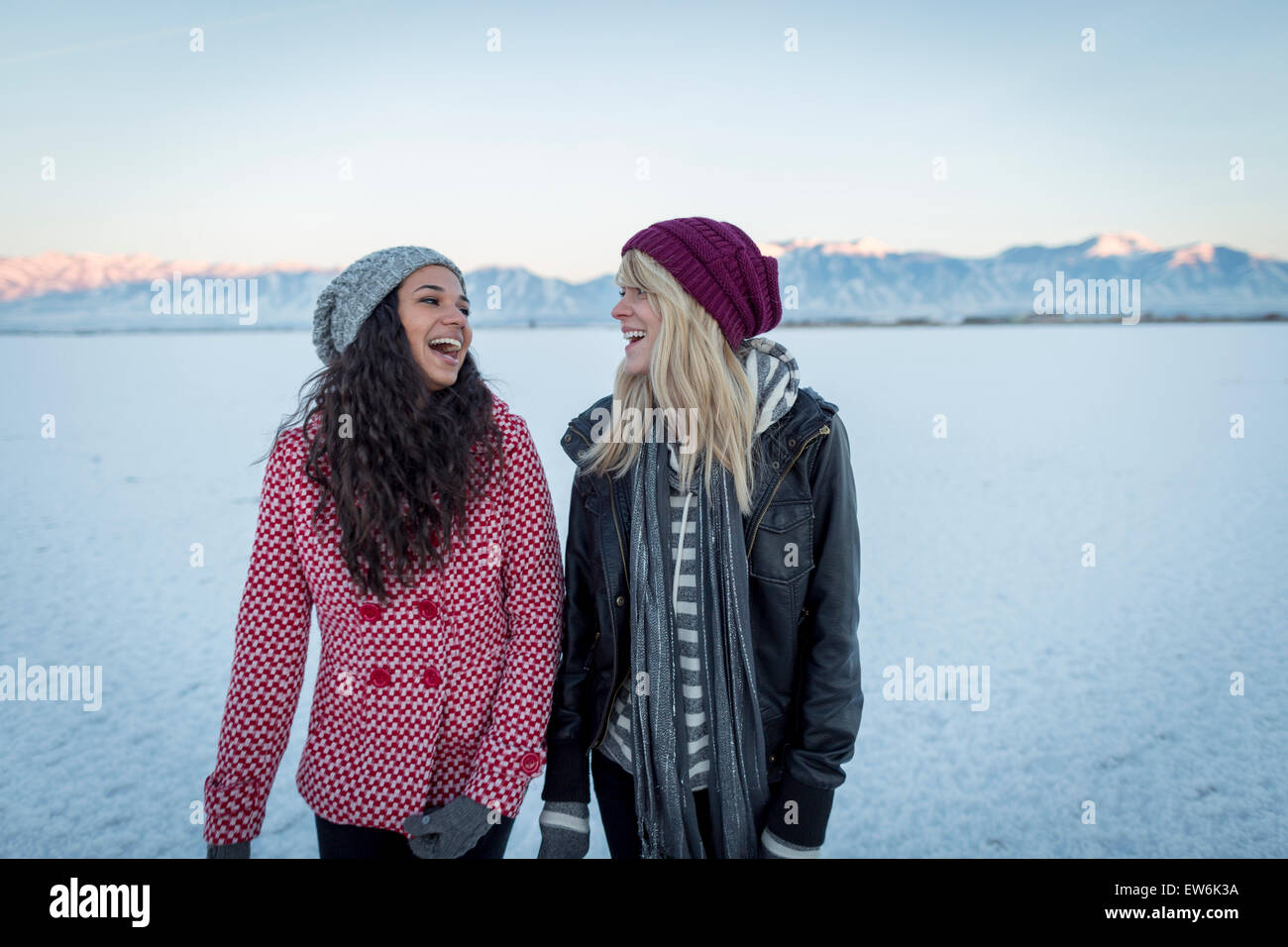 Two young women laugh outside in winter Stock Photo - Alamy