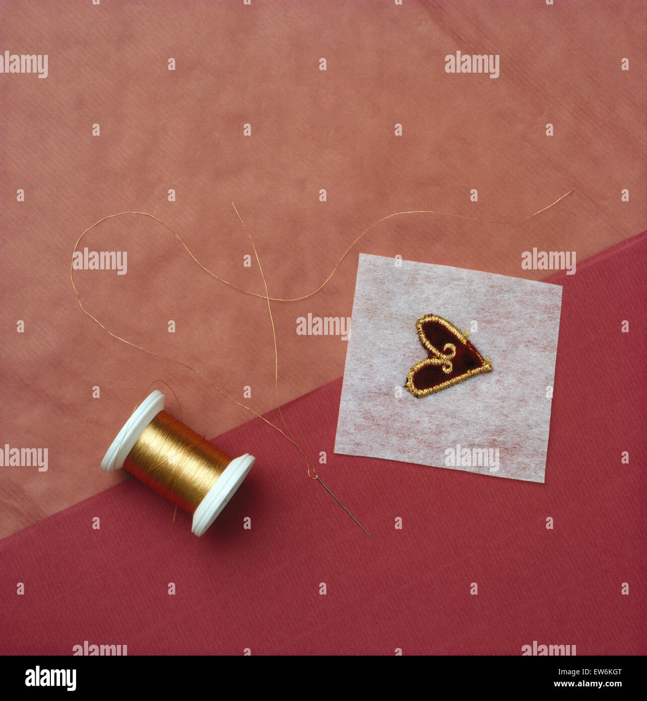 Gold thread and an appliqued heart for making home made pictures Stock ...