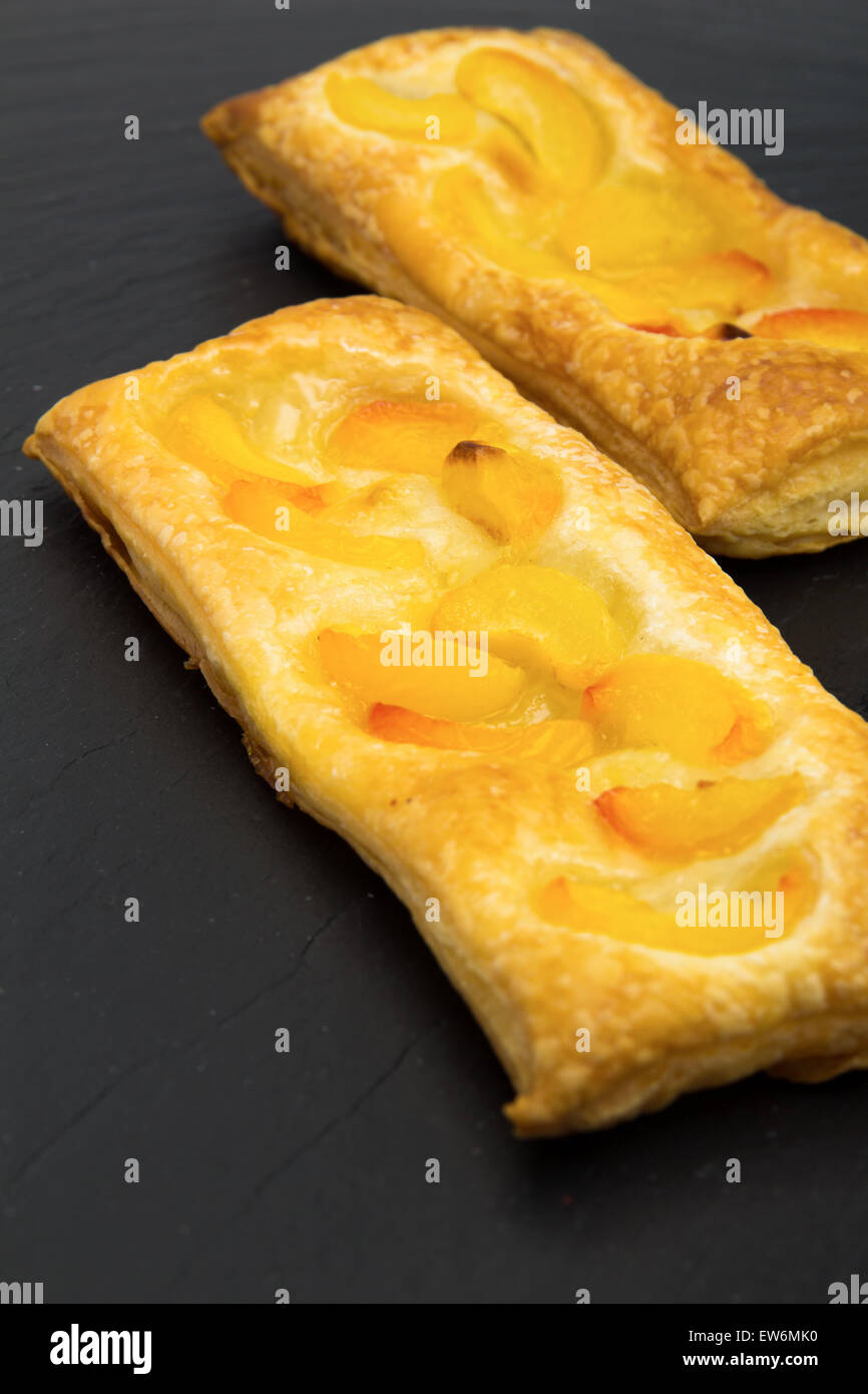 puff pastry slices with apricot on black slate stone surface Stock ...