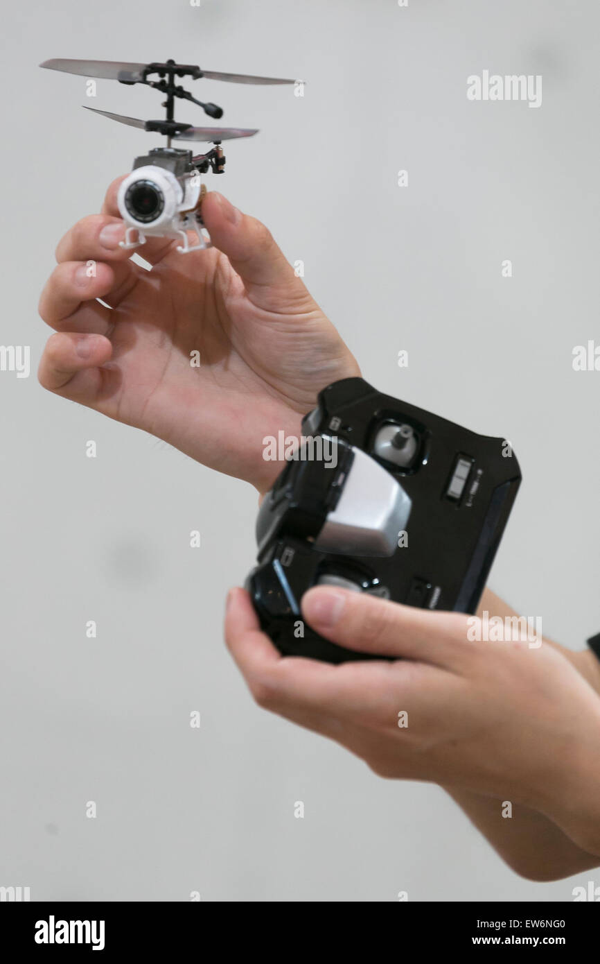 An exhibitor shows a helicopter ''Nano Falco Digi Cam'' during the ...