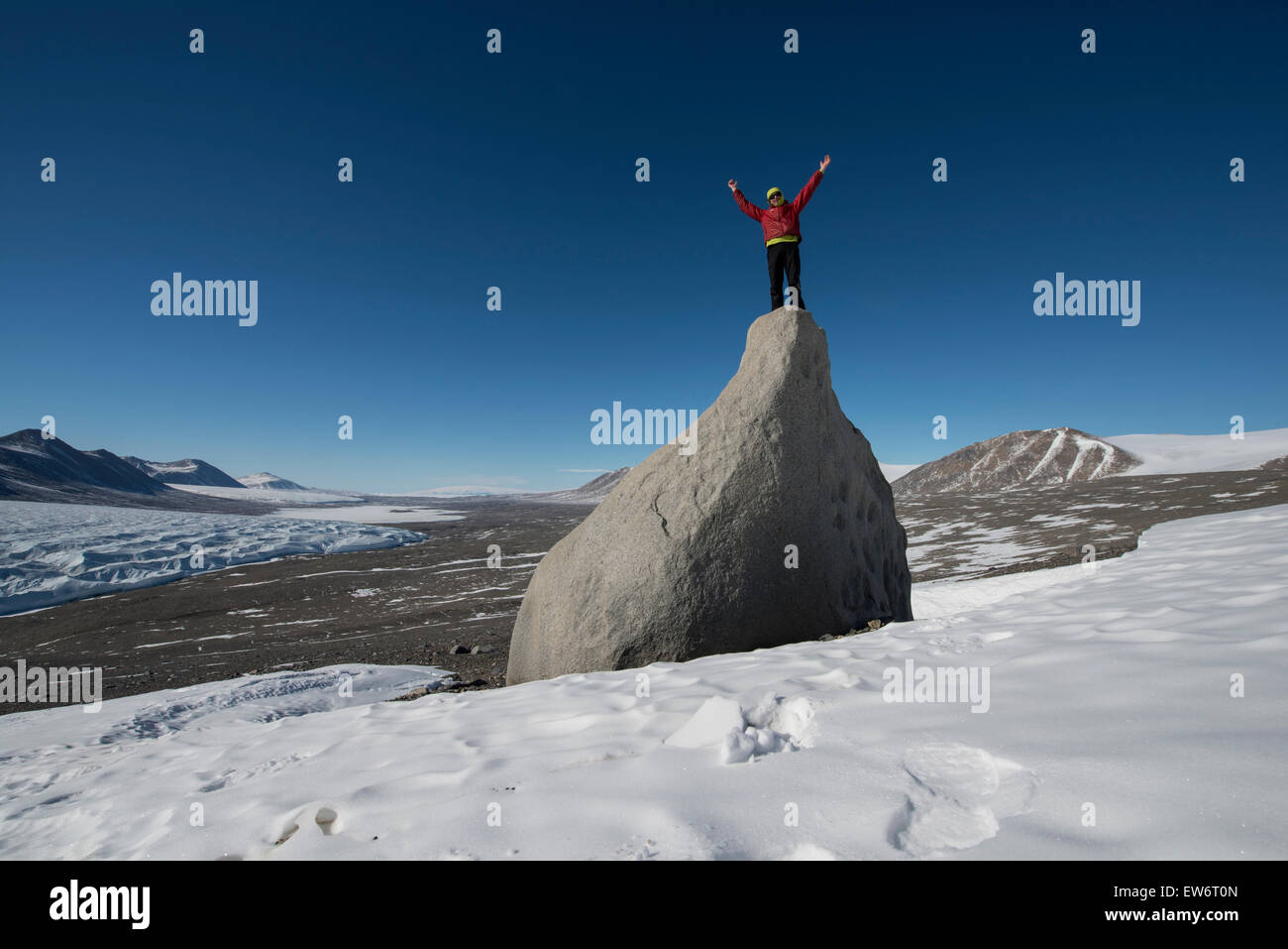 Man stands on top of boulder in the Taylor Valley, Antarctica Stock ...