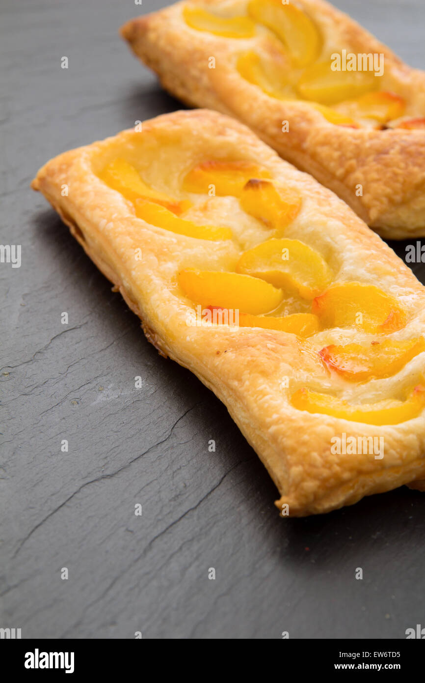 puff pastry slices with apricot on black slate stone surface Stock ...