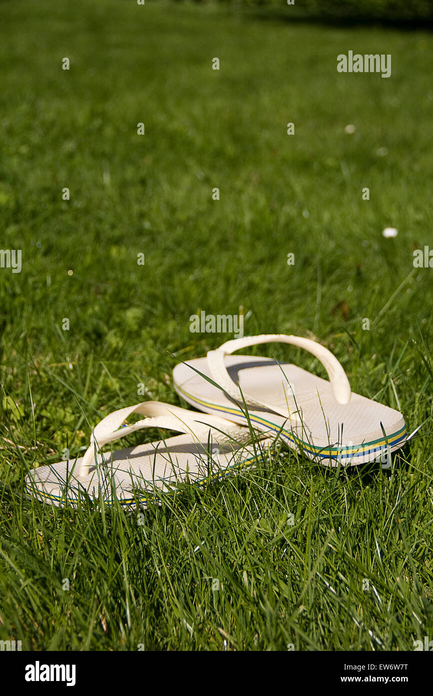 pair of flip flops on grass Stock Photo - Alamy