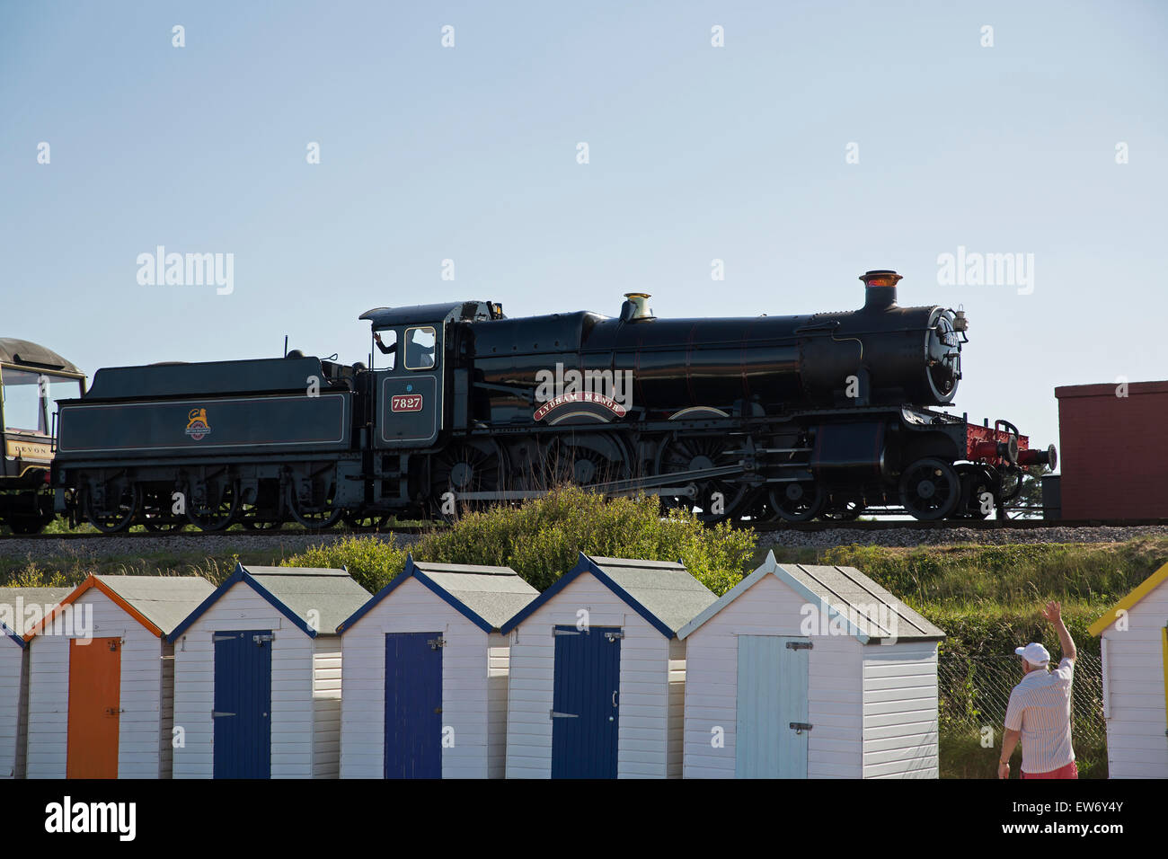 Lydham Manor 7827 steam locomotive passes behind the beach huts in ...