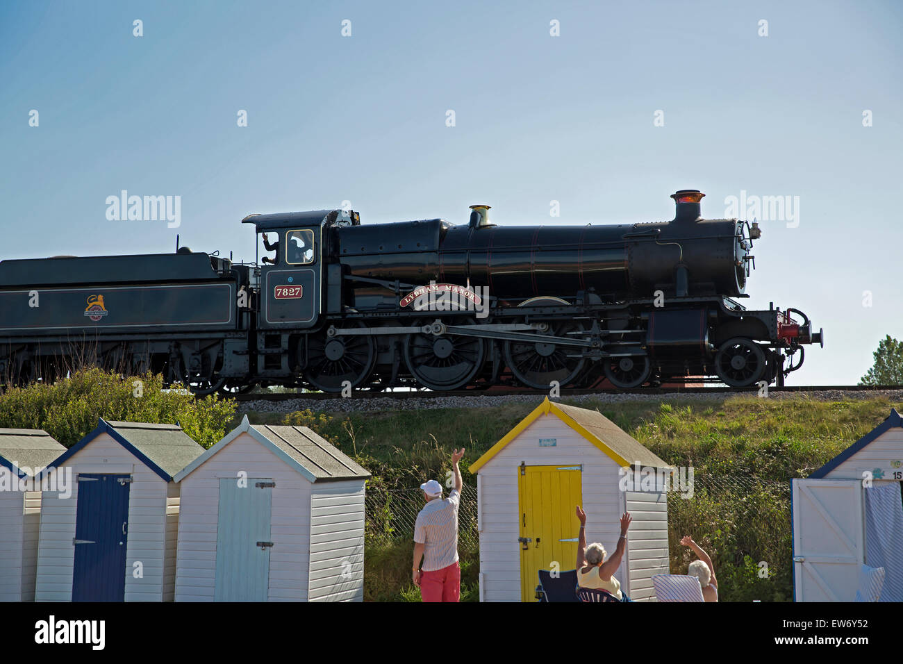 Lydham Manor 7827 steam locomotive passes behind the beach huts in ...
