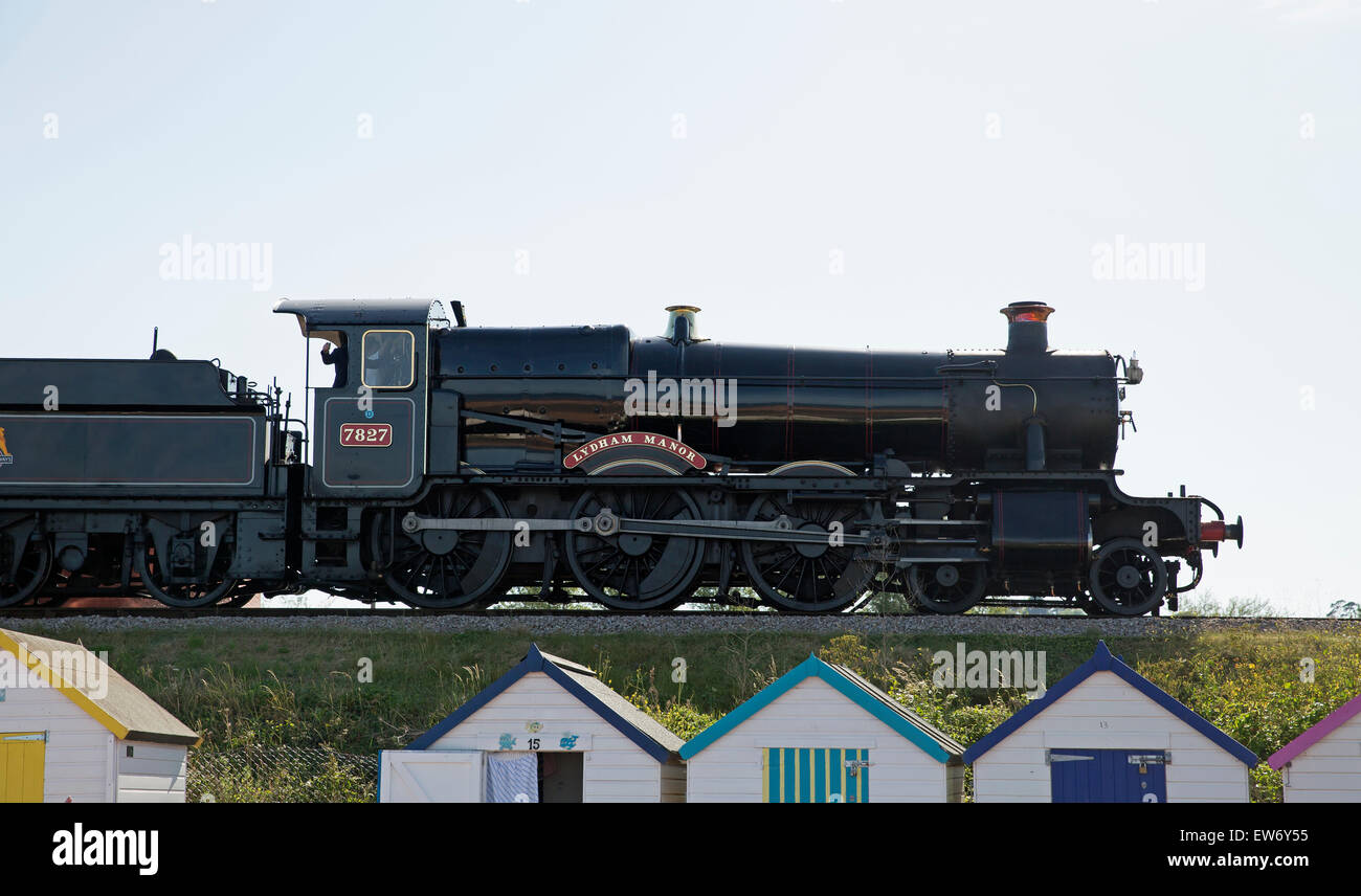 Lydham Manor 7827 steam locomotive passes behind the beach huts in ...