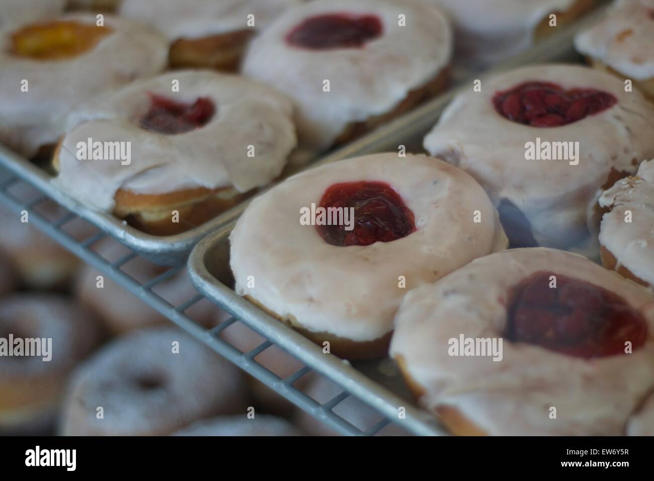 Glazed raspberry donuts Stock Photo - Alamy