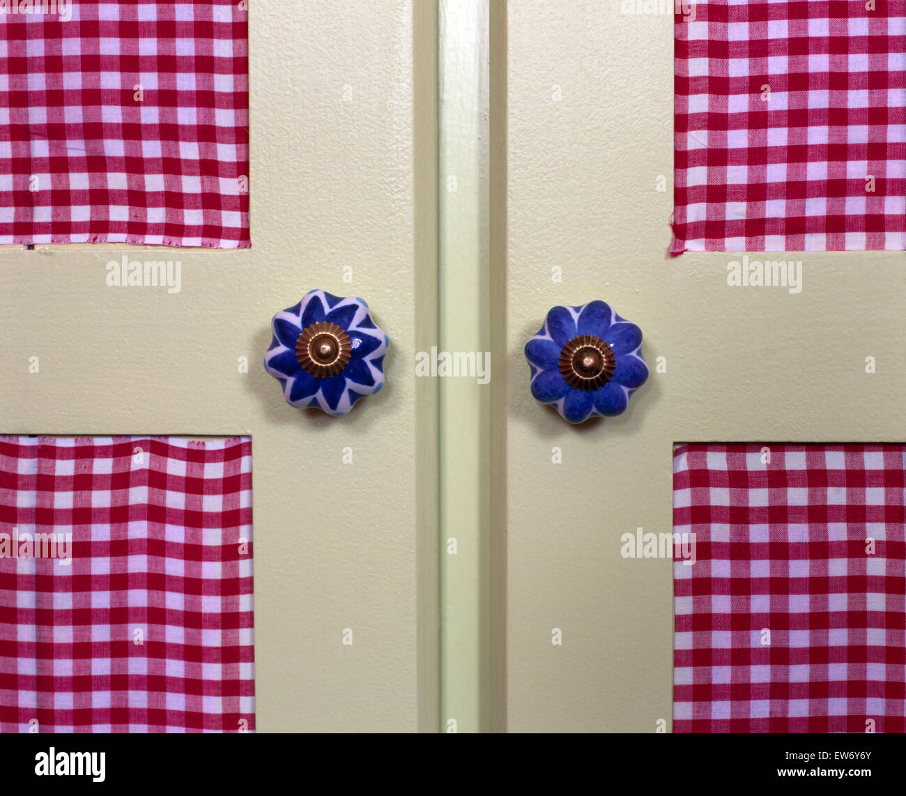 Close-up of china handles on a newly renovated cupboard with pink ...
