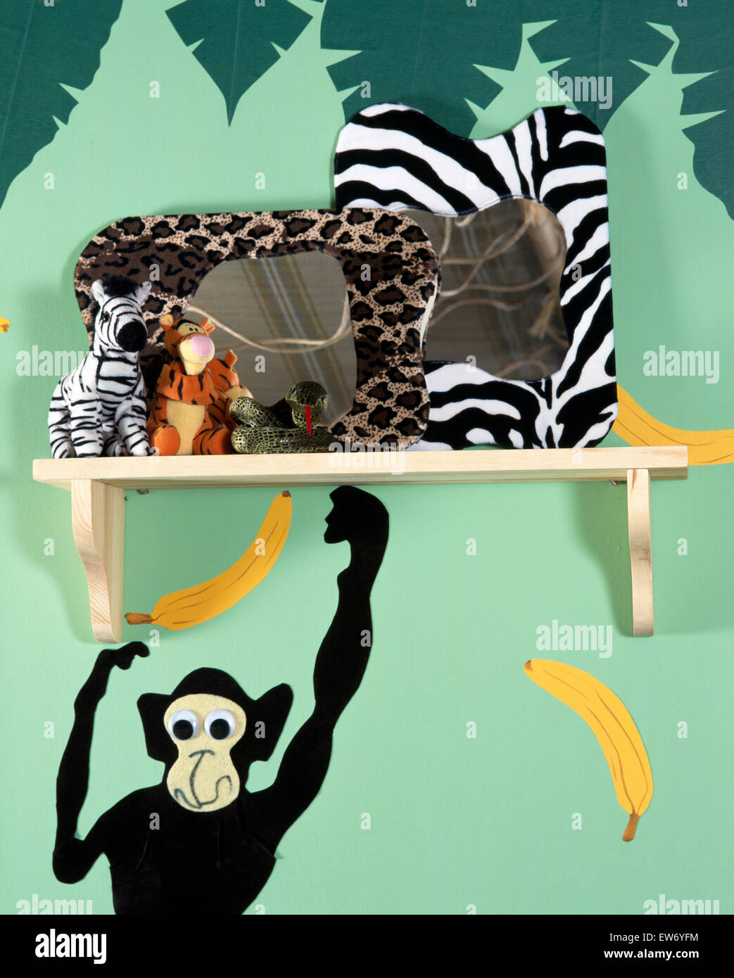 Animal print mirrors on a basic wooden shelf above a hand painted ...