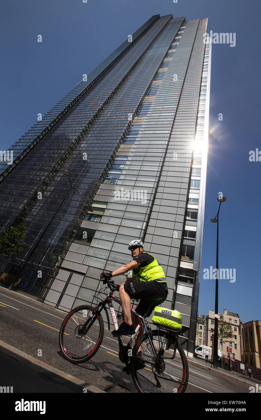 Cyclist riding past a skyscraper building in London Stock Photo - Alamy