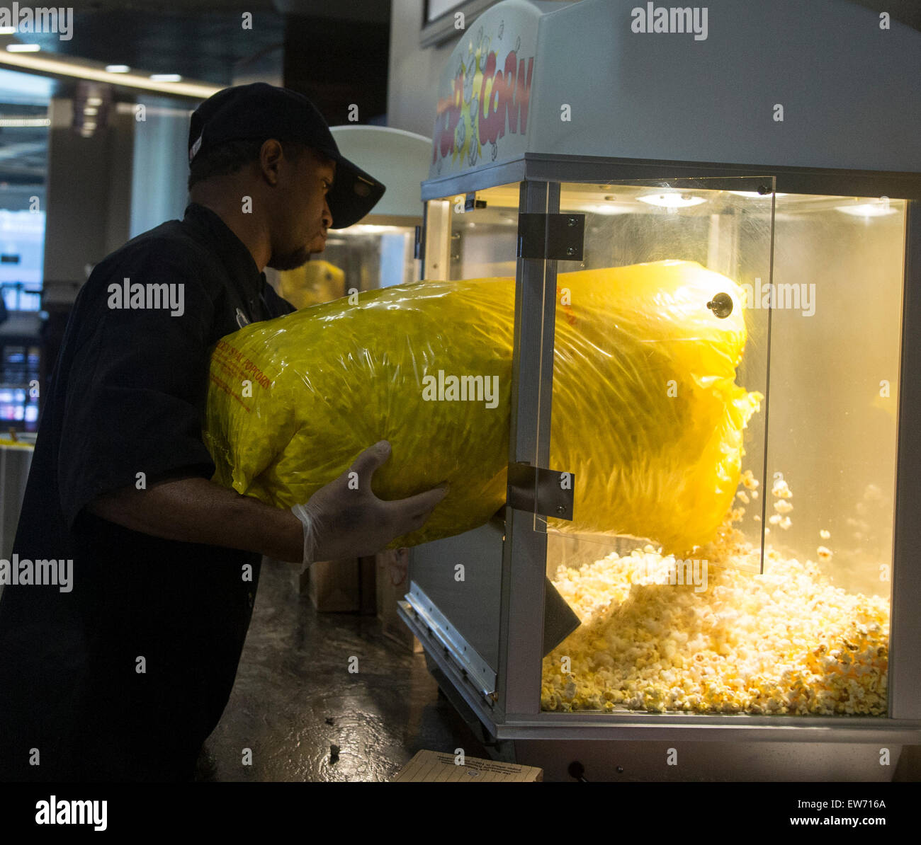 A popcorn machine being refilled at at baseball game Stock Photo - Alamy