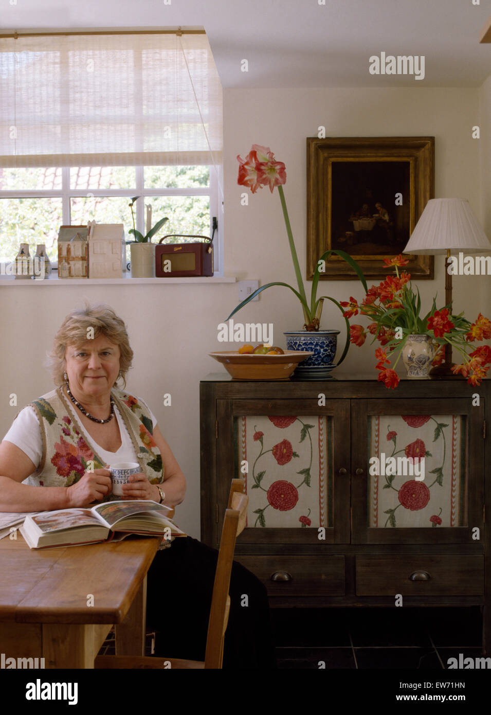 Portrait of older woman sitting at table in cottage dining room FOR ...