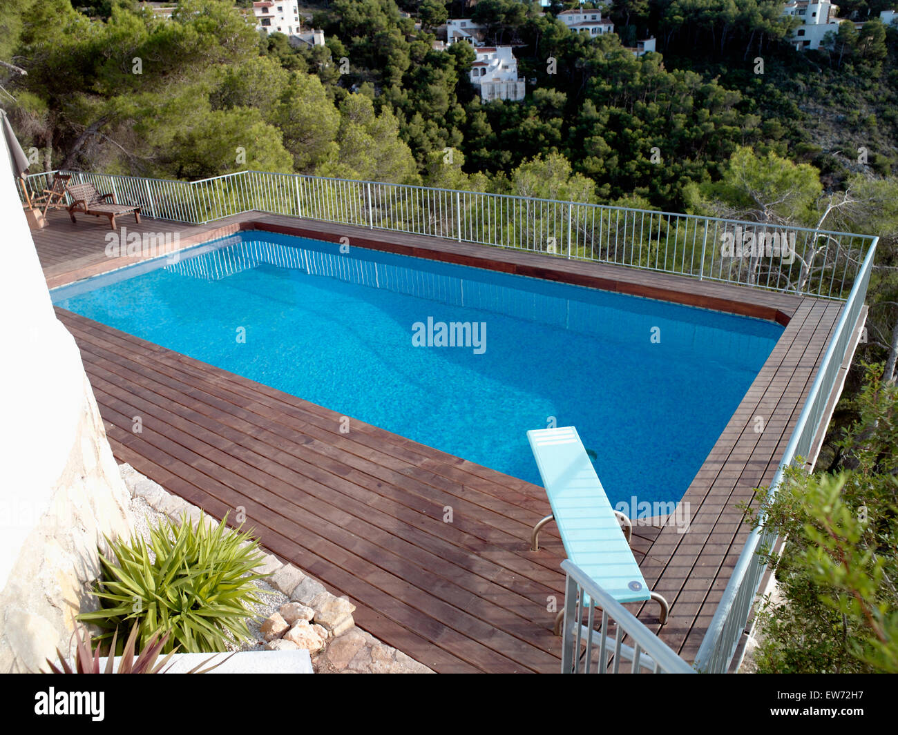 Birdseye view of turquoise swimming pool with with diving board and ...