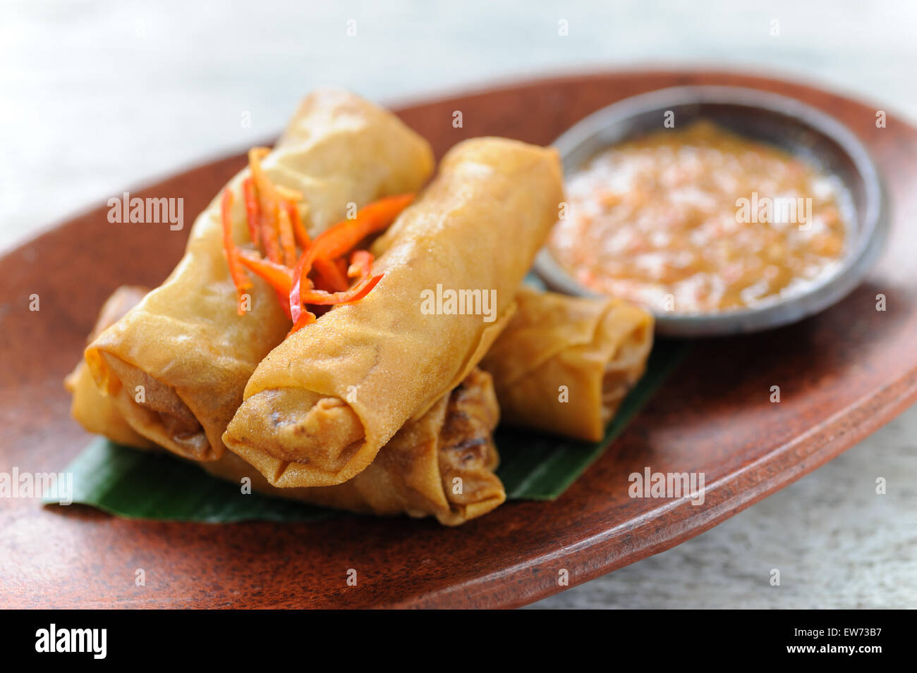 Indonesian-style spring rolls served with sambal dipping sauce and red ...