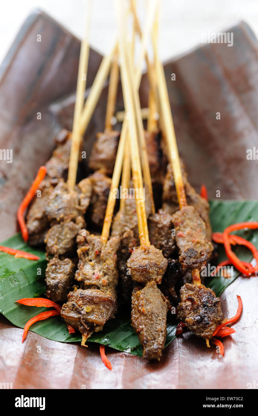 Indonesian beef sate garnished with red chillies Stock Photo - Alamy