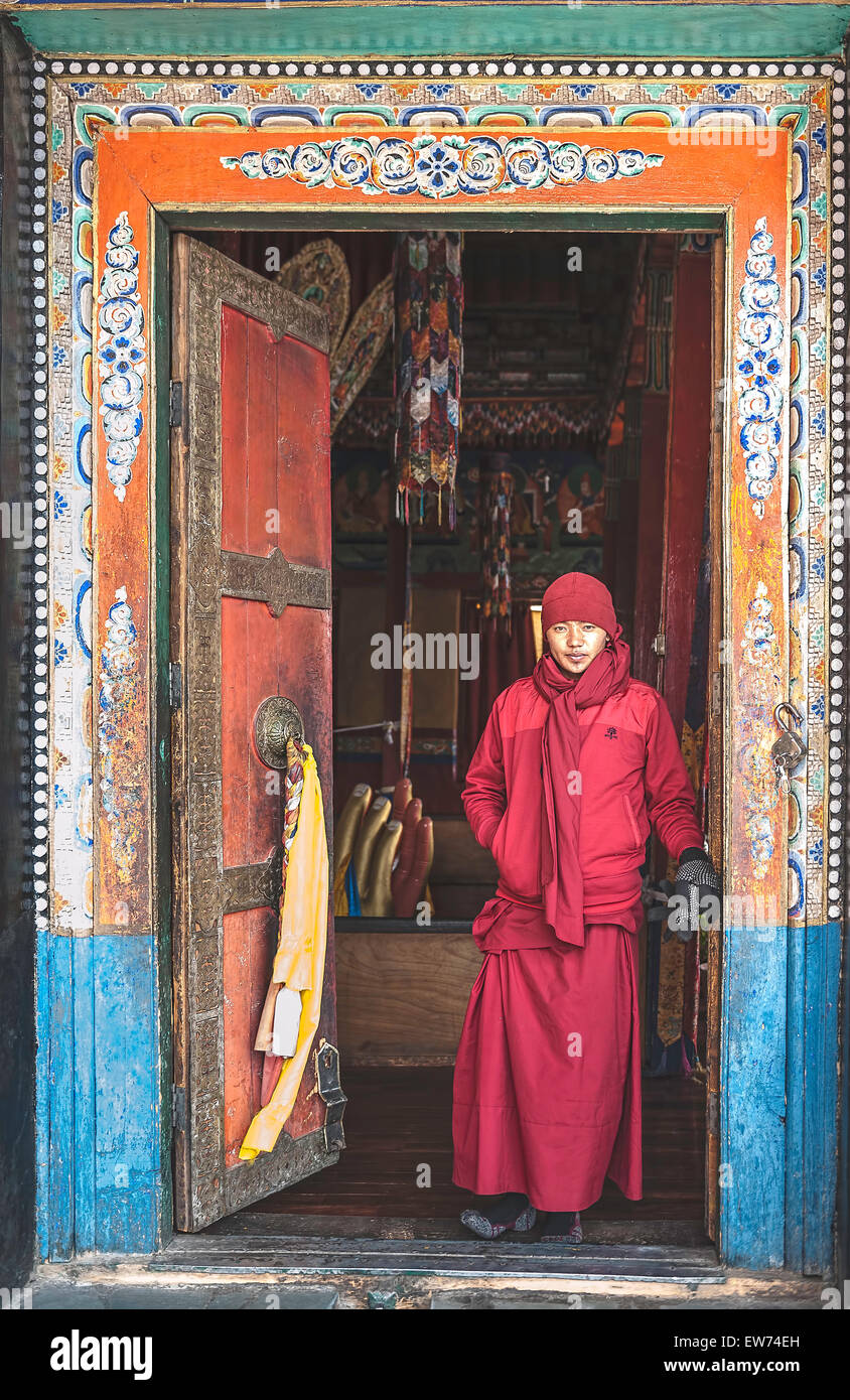 Monk is standing at monastery gate Stock Photo - Alamy