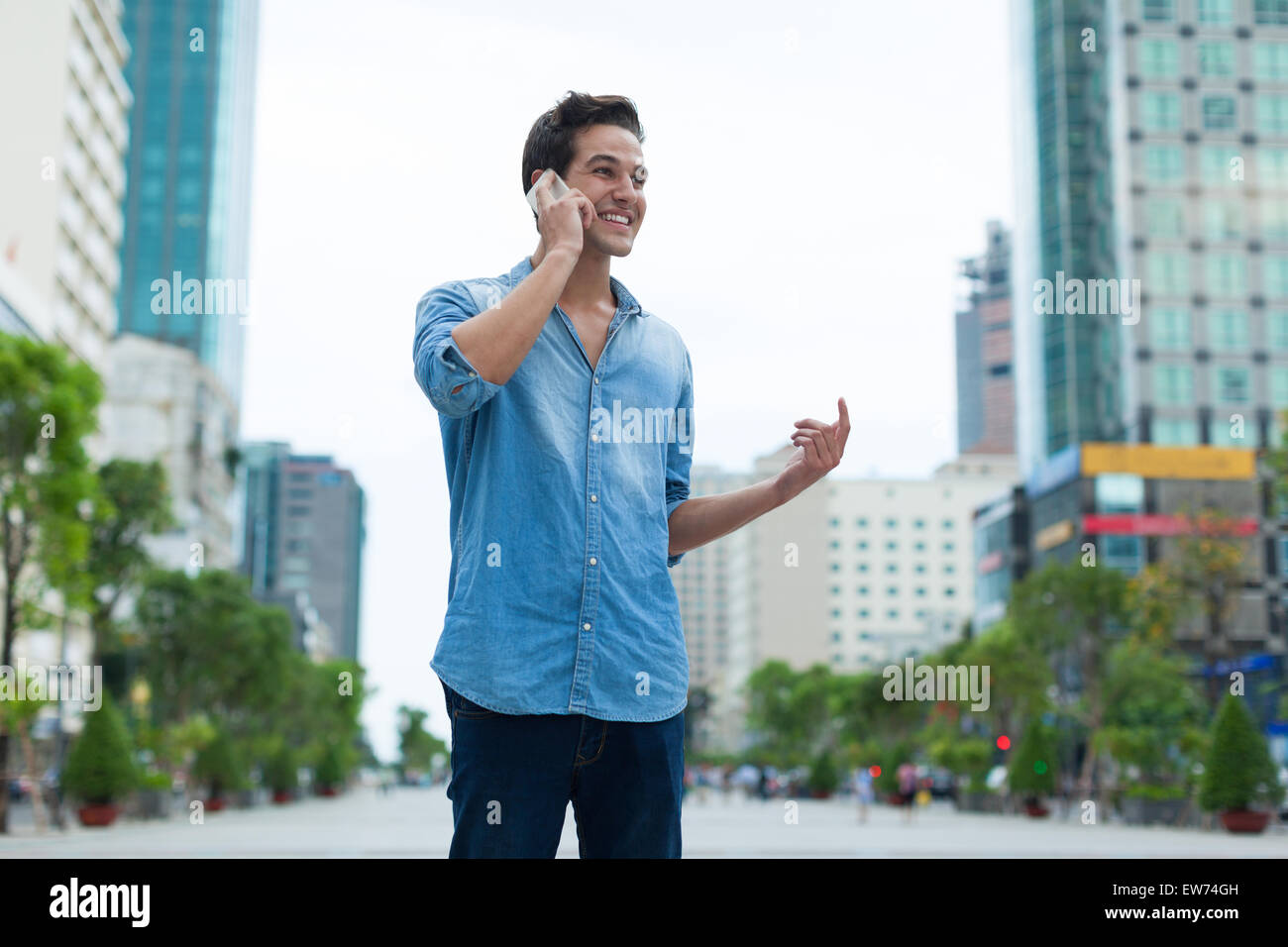 Handsome man cell phone call smile outdoor city street Stock Photo - Alamy