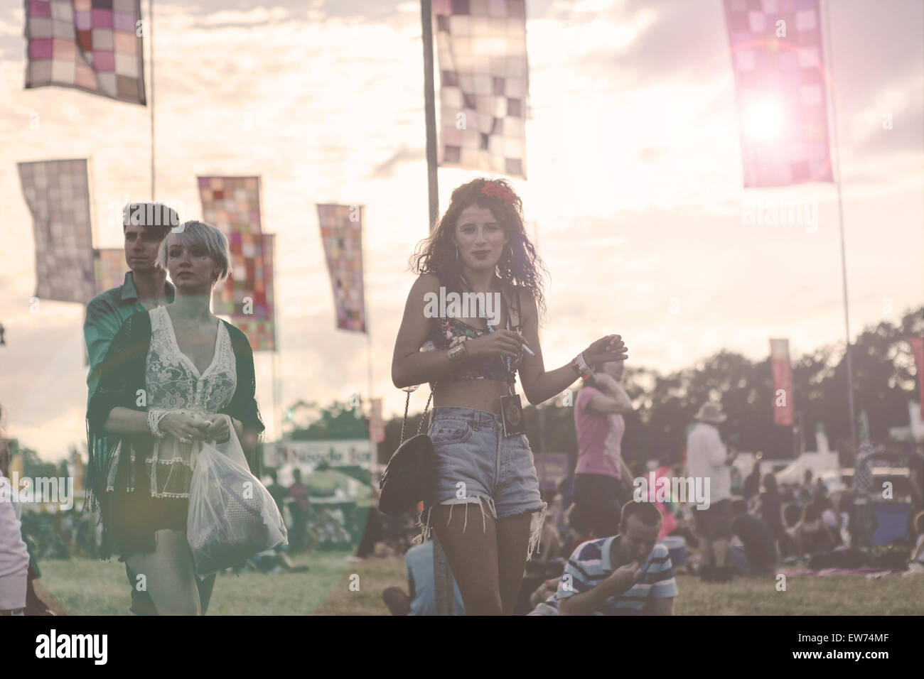 Girls walking at music festival in the sunset Stock Photo - Alamy
