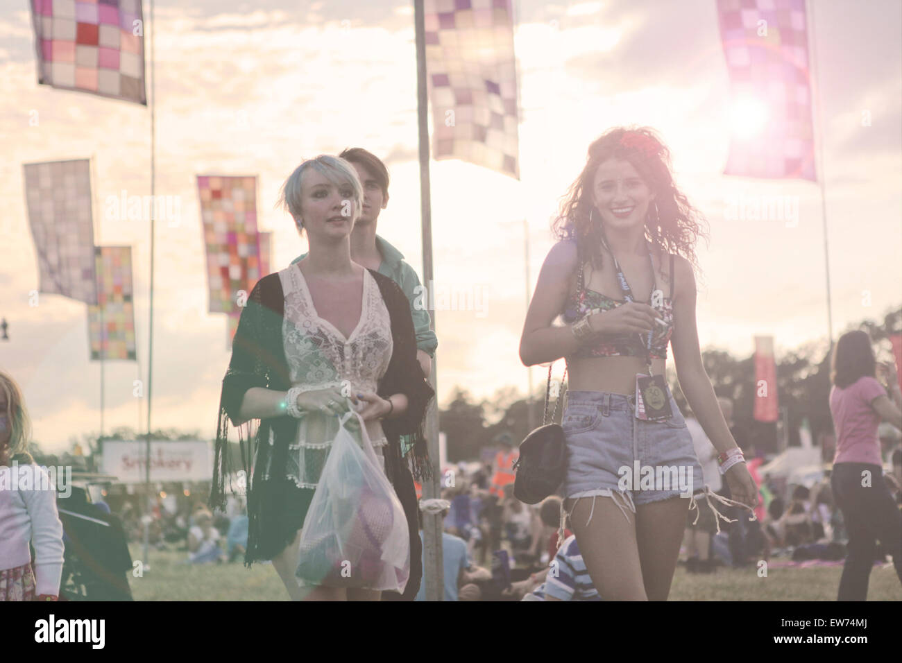 Girls walking at music festival in the sunset Stock Photo - Alamy