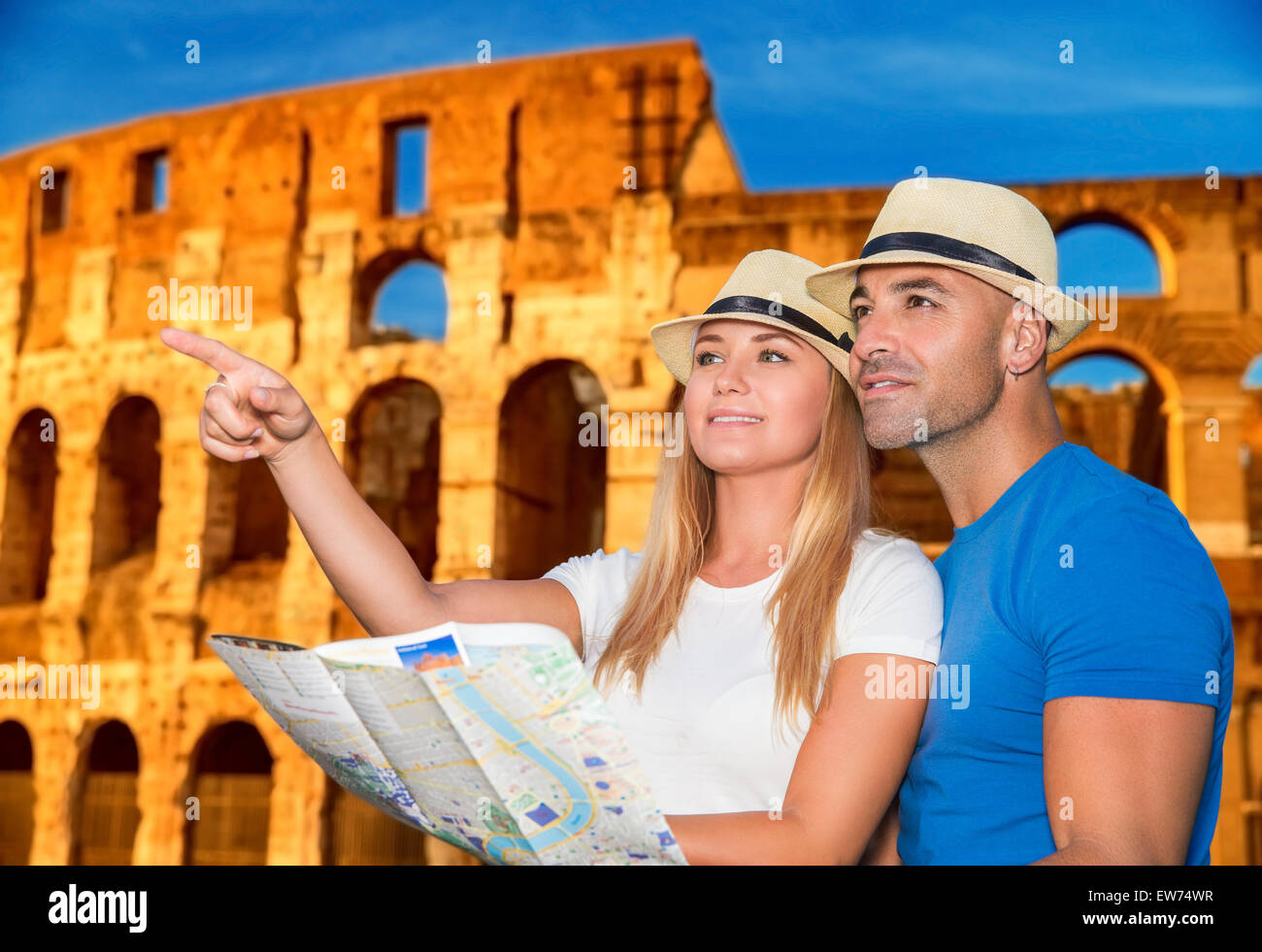 Beautiful active couple with map standing on Coliseum background and ...