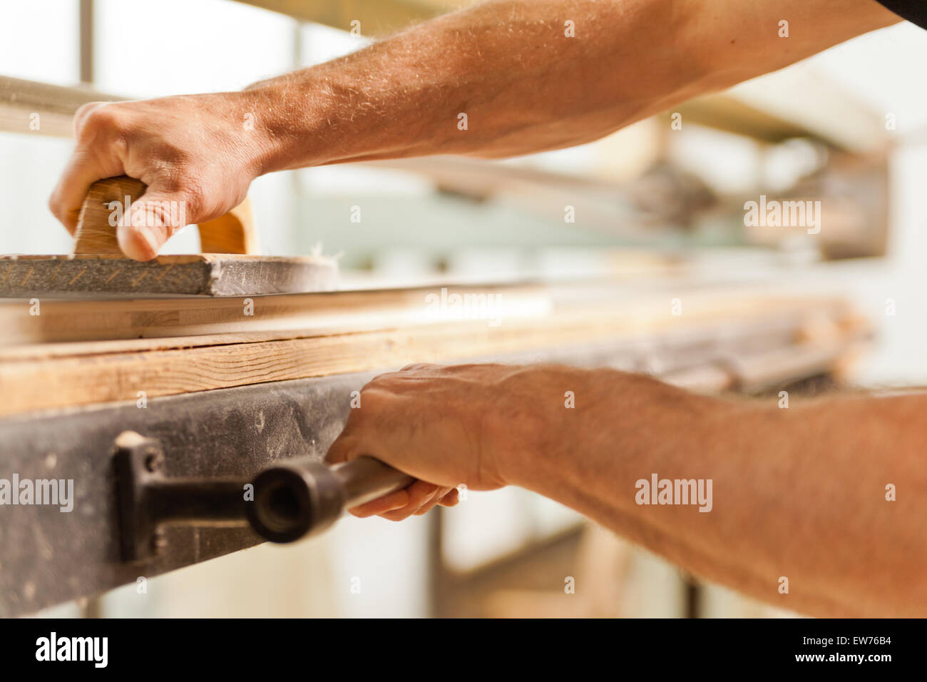 robust hands of a carpenter wood smoothing with belt sander Stock Photo ...