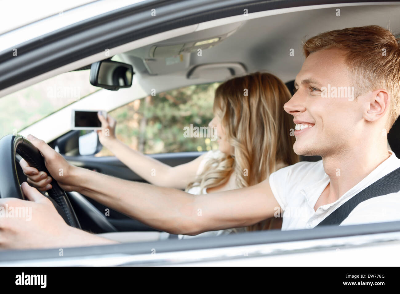 Young couple in the car Stock Photo - Alamy