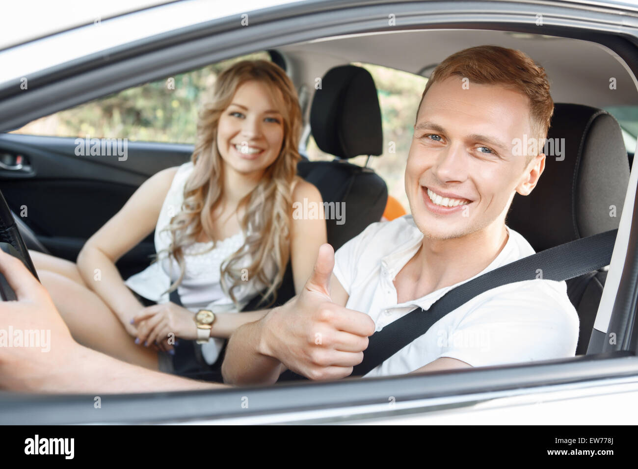 Young couple in the car Stock Photo - Alamy