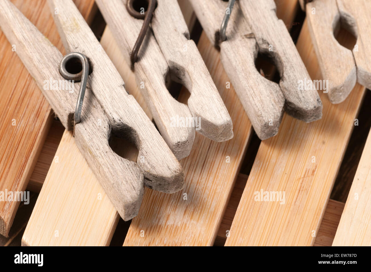 Old wooden clothes pins on a timber board, close-up Stock Photo - Alamy