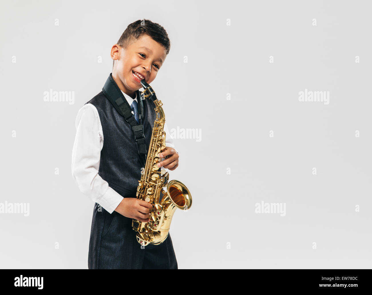 six years old boy plays saxophone at studio Stock Photo - Alamy