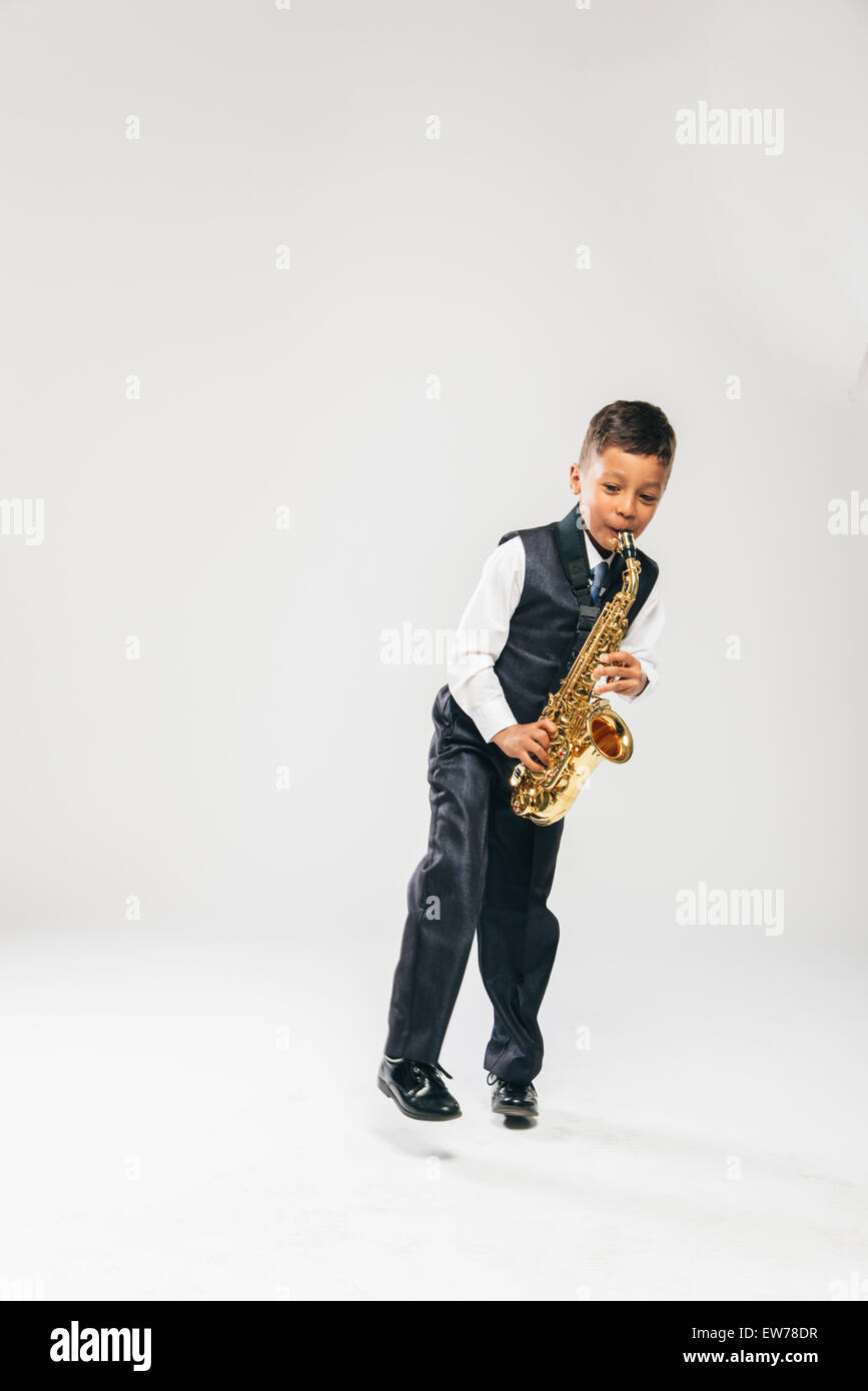 six years old boy plays saxophone at studio Stock Photo - Alamy