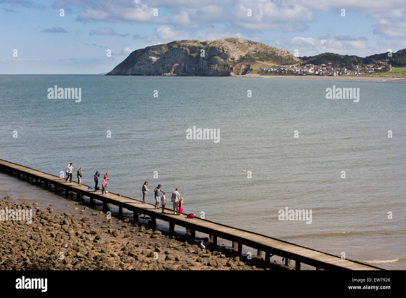 UK, Wales, Conwy, Llandudno North Beach, view towards Little Orme, across boat jetty at low tide ...