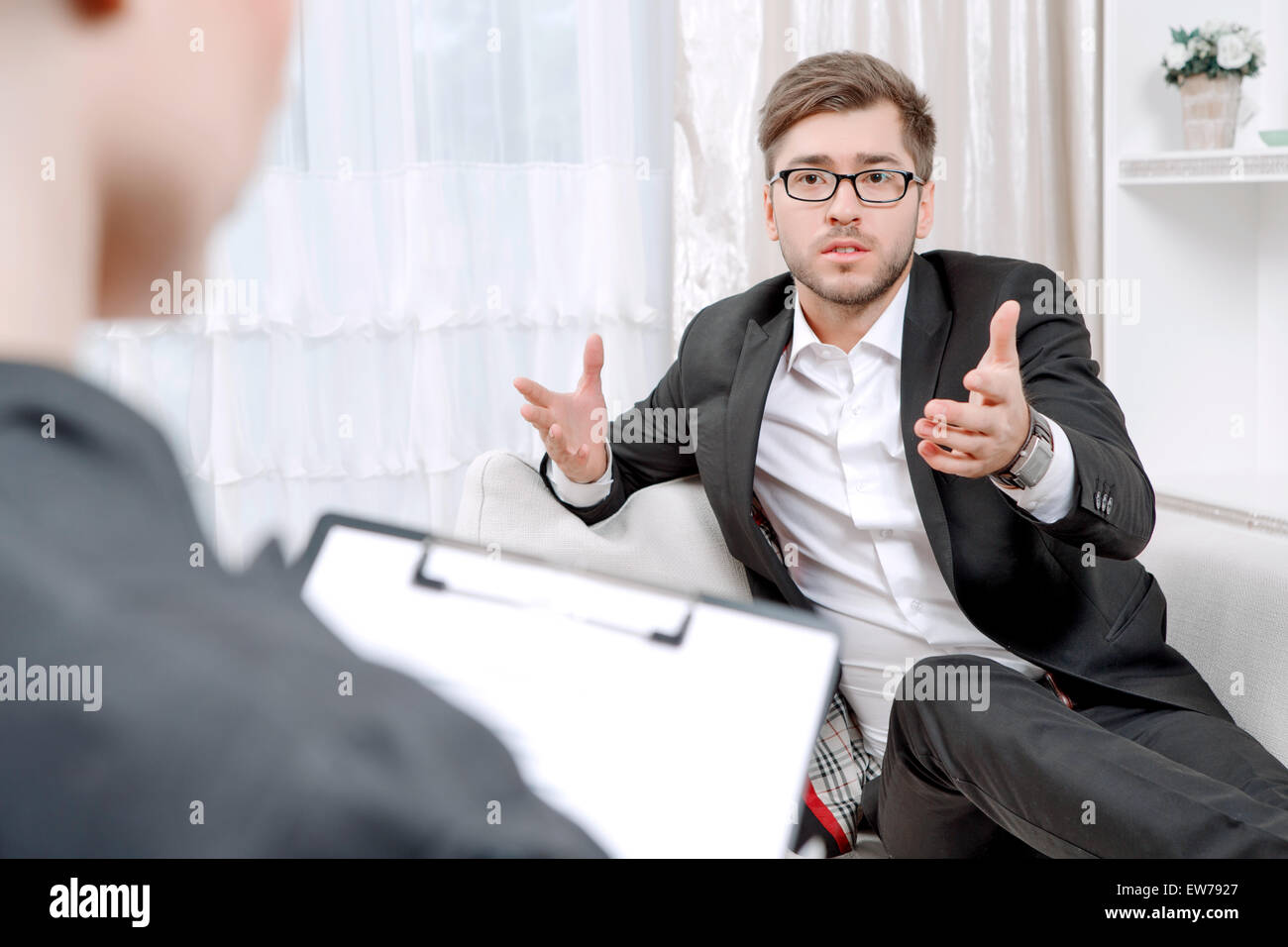 Young man with his psychologist Stock Photo - Alamy