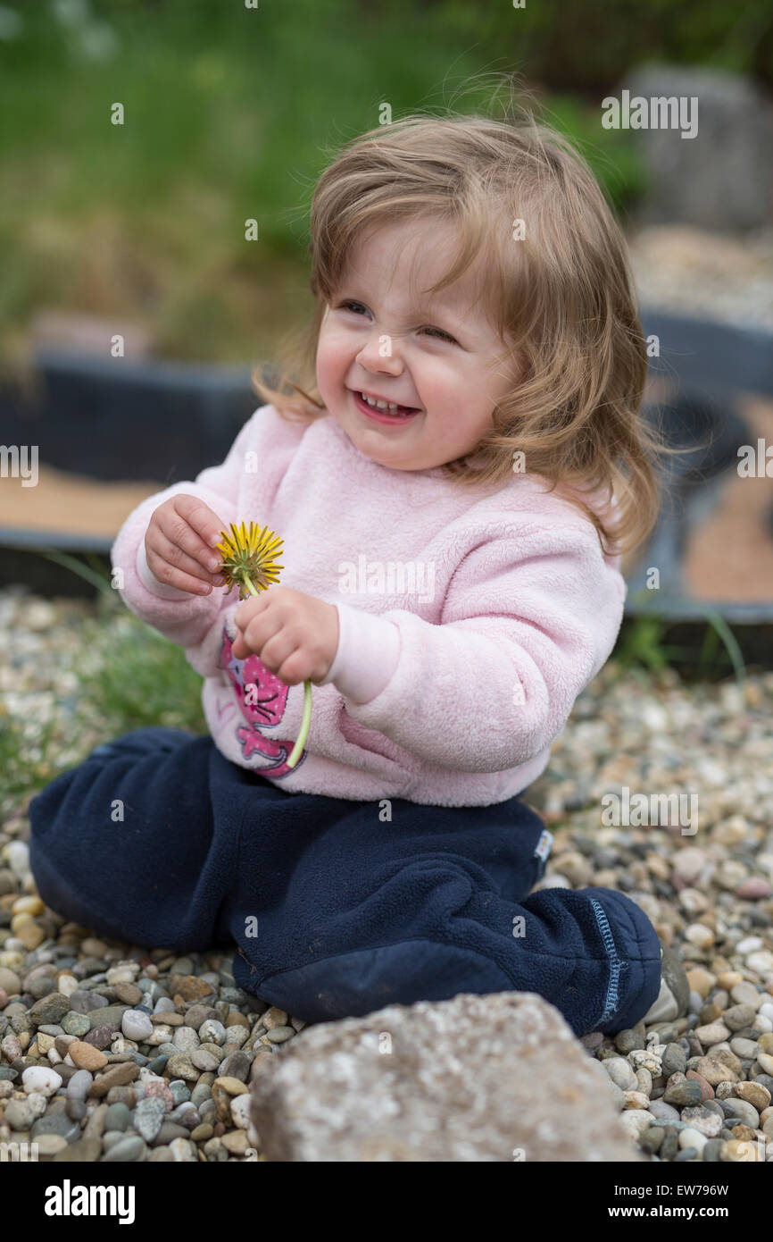 Little girl playing with flower Stock Photo - Alamy