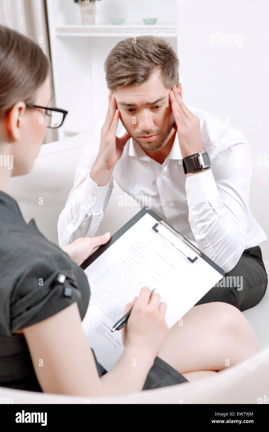 Young man with his psychologist Stock Photo - Alamy